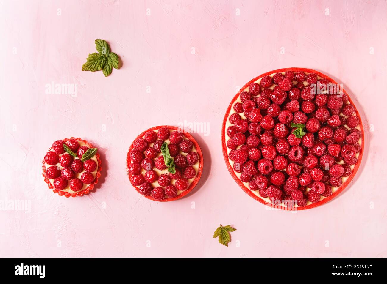 Variety of red raspberry shortbread tarts and tartlets with lemon ...