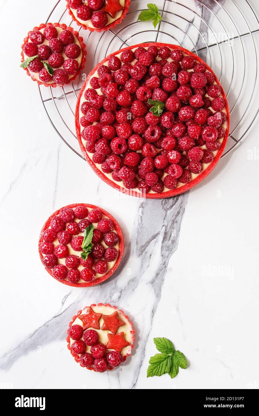 Variety of red raspberry shortbread tarts and tartlets with lemon ...