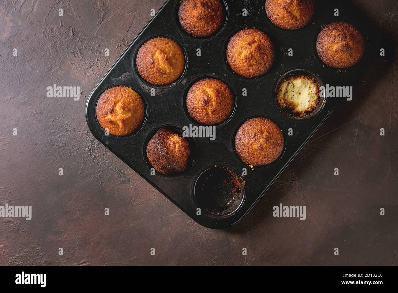 Fresh baked homemade lemon cakes muffins in black teflon baking dish ...