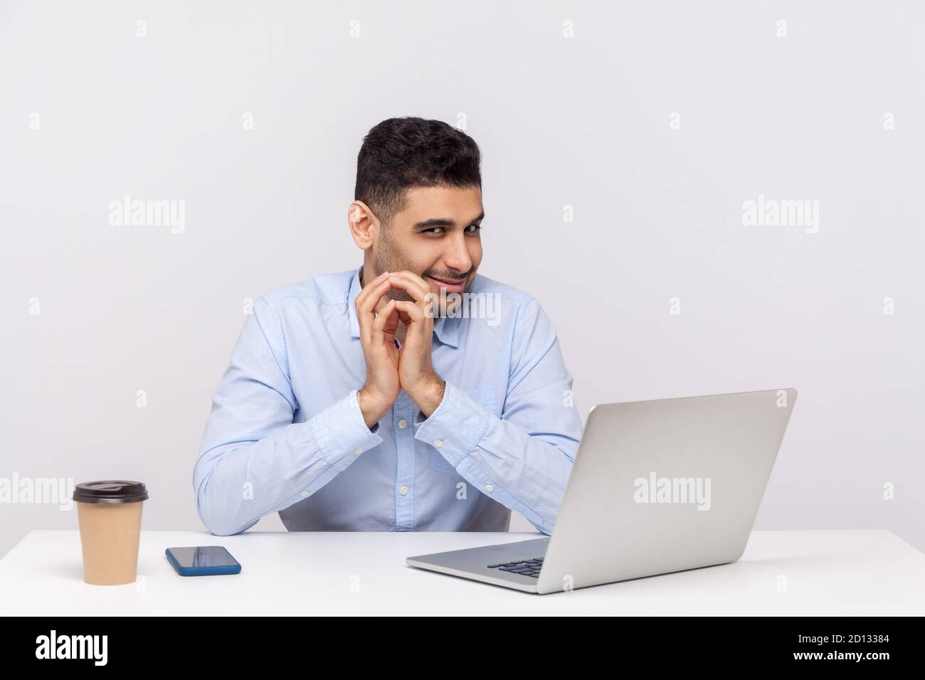 Sneaky scheming businessman sitting office workplace with laptop on ...