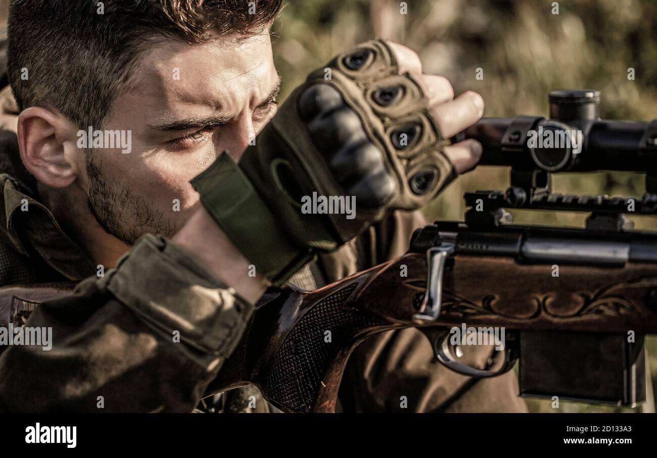 Hunter is aiming. Shooter sighting in the target. The man is on the ...