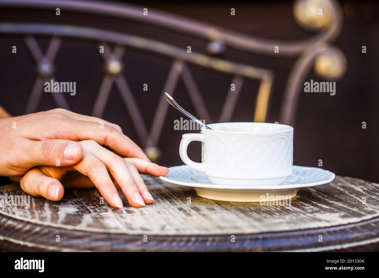 ouple holding hands, a cup of hot coffee. Couple enjoying coffe. Female ...