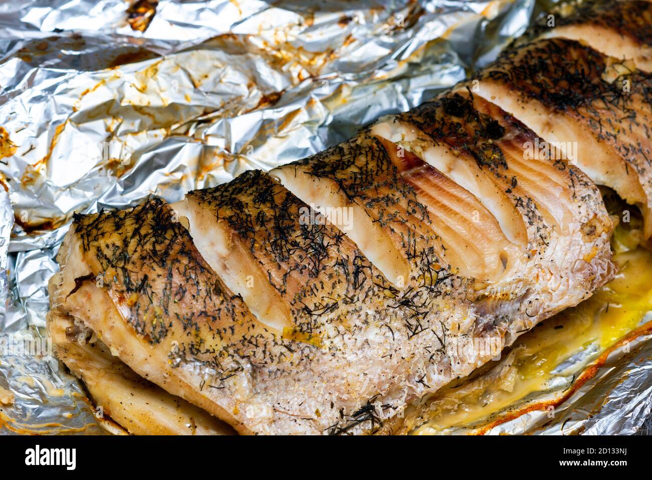 lying down fish cooking in the oven, pike lie in a foil Stock Photo - Alamy