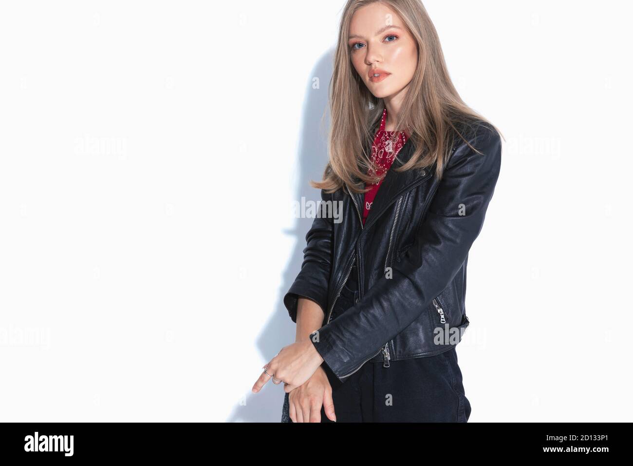 Charming fashion model gesturing being arrested and wearing leather ...