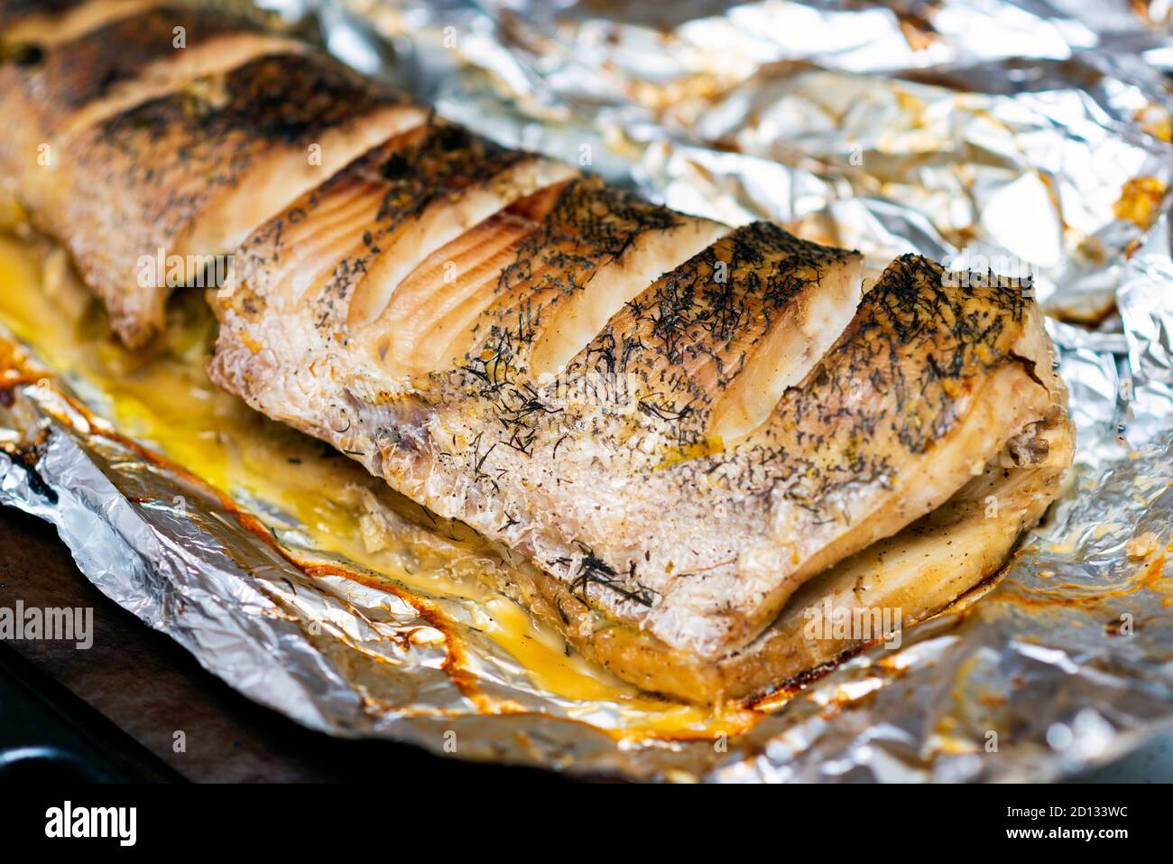 lying down fish cooking in the oven, pike lie in a foil Stock Photo - Alamy