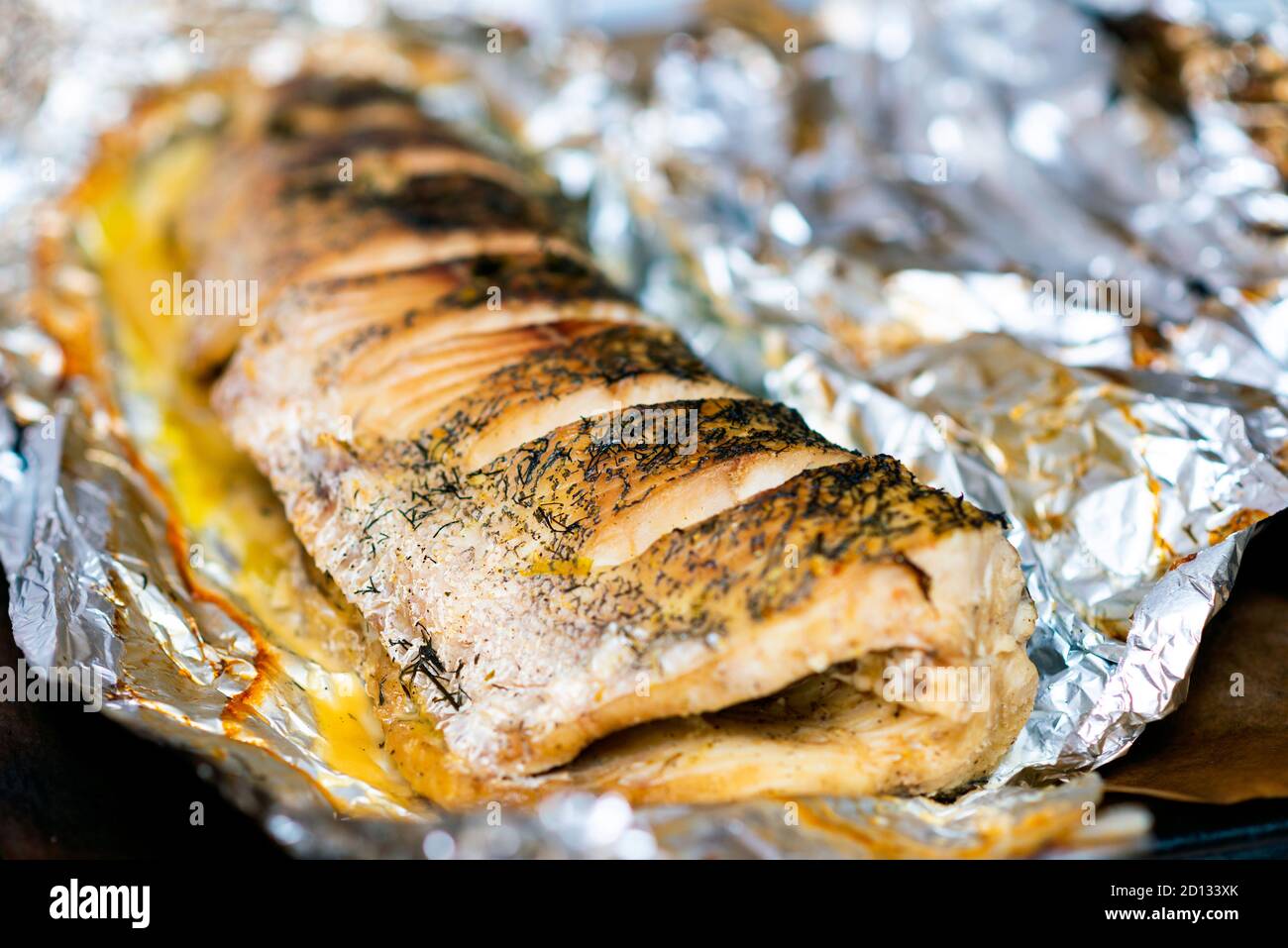 lying down fish cooking in the oven, pike lie in a foil Stock Photo - Alamy