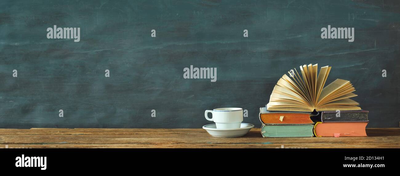 Stack of books, open book and cup of coffee. Reading,literature ...