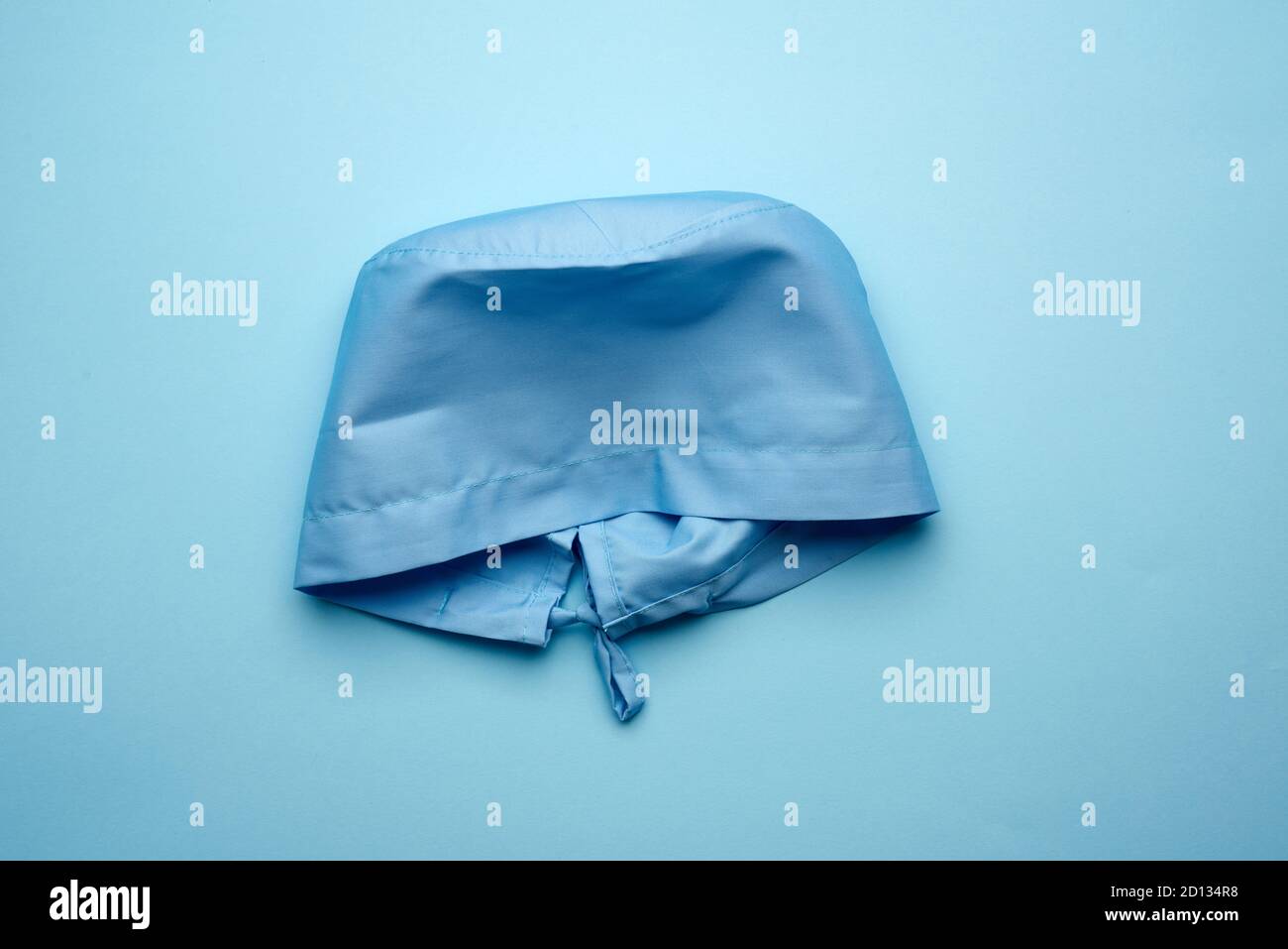 blue textile medical cap with ties for doctor, surgeon on blue ...