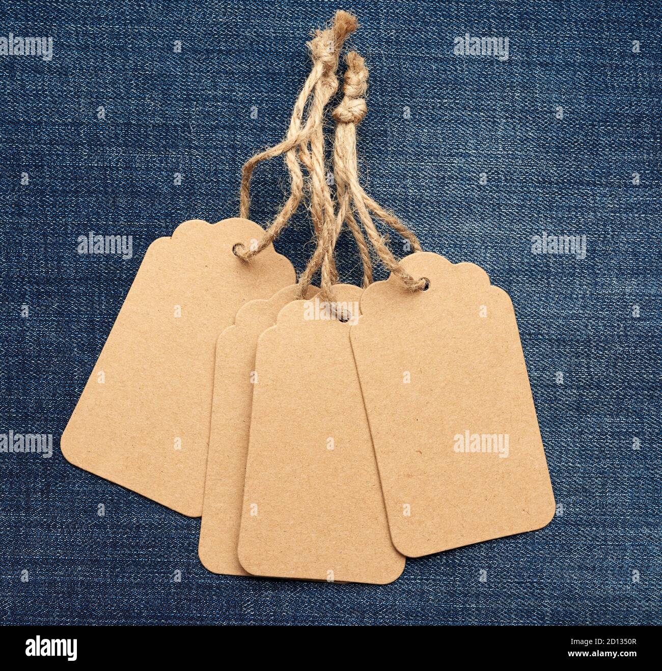 empty paper brown rectangular price tag on a rope, blue jeans ...
