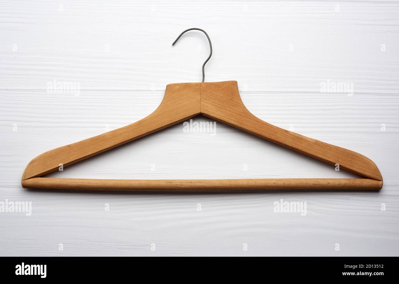 vintage wooden hanger with iron hook on white background, top view ...