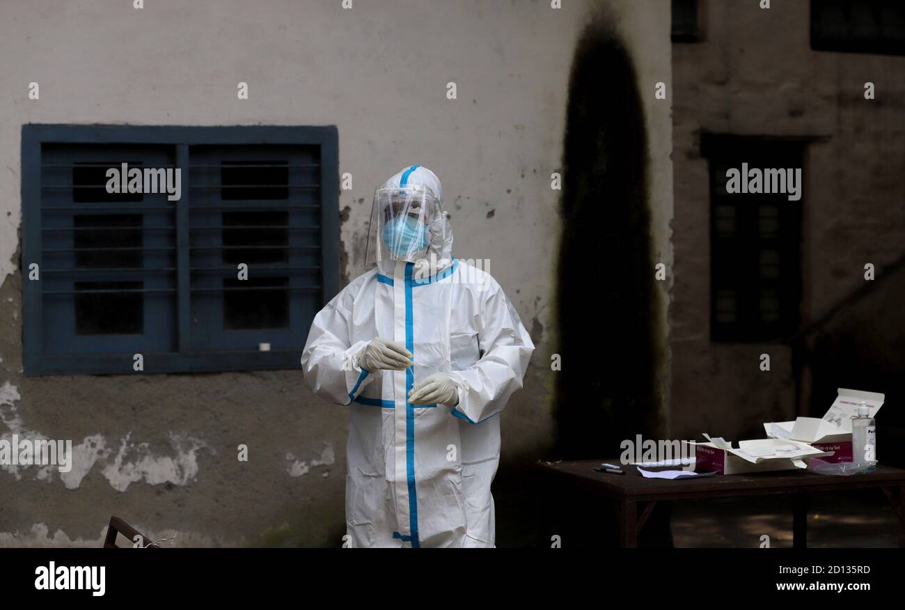 A medical staff takes swab sample of a coronavirus suspect person at a ...