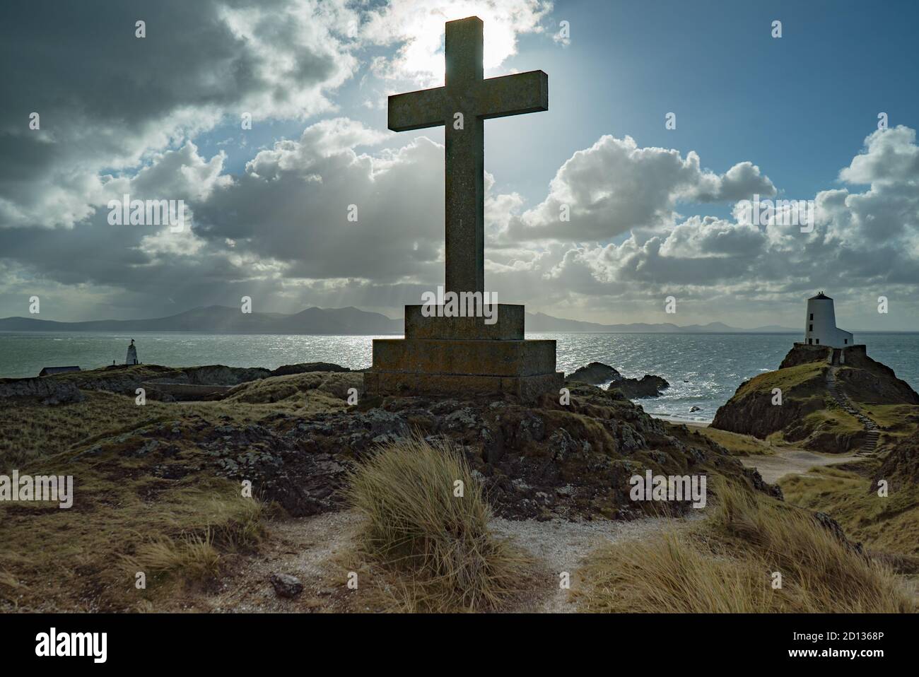 The cross on the hill overlooking the lighthouse on the Llanddwyn ...