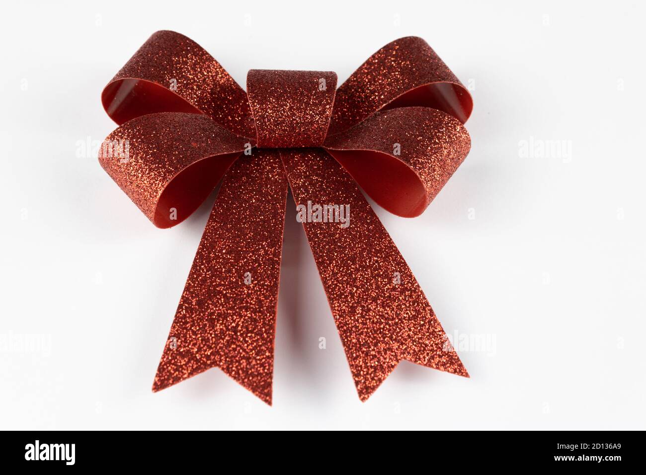 red glitter bow on white background. christmas object Stock Photo - Alamy