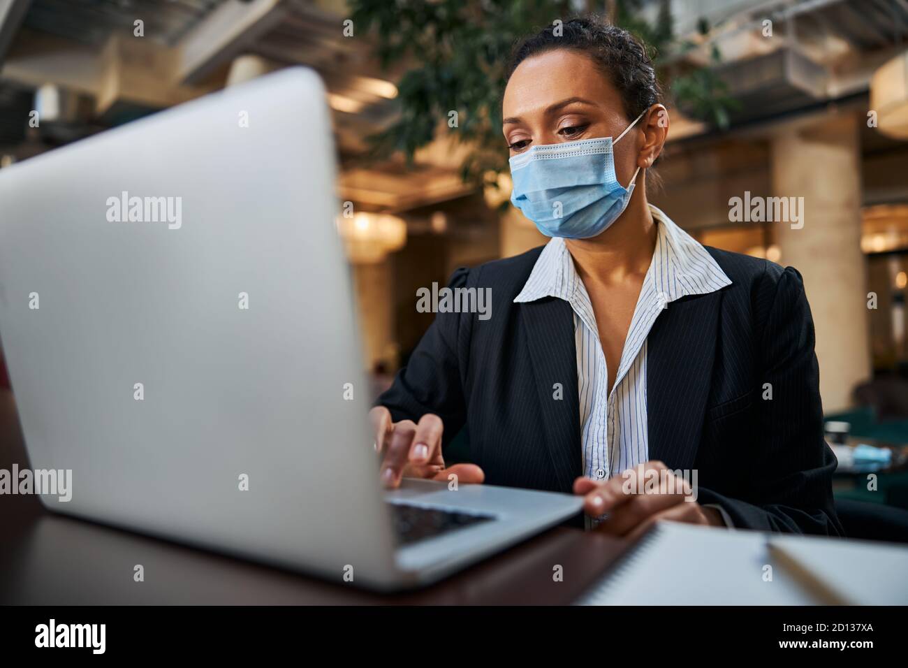 Close up of serious female looking at keyboard Stock Photo - Alamy
