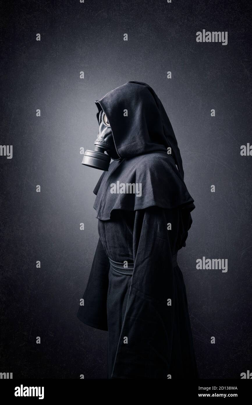 Man in a gas mask and hooded cloak. Environment pollution Stock Photo ...