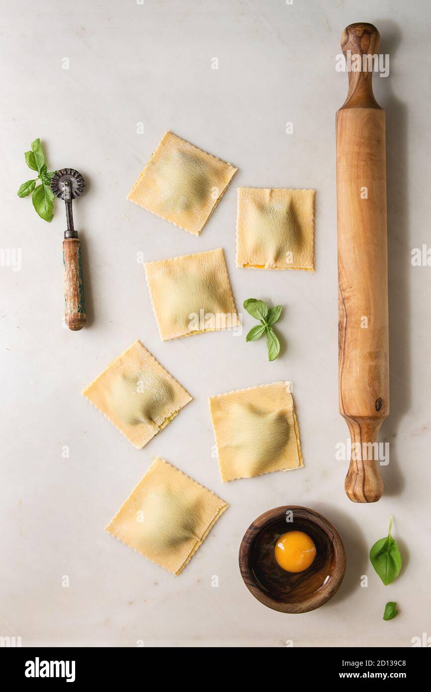 Homemade raw uncooked italian pasta ravioli staffed by spinach ricotta ...