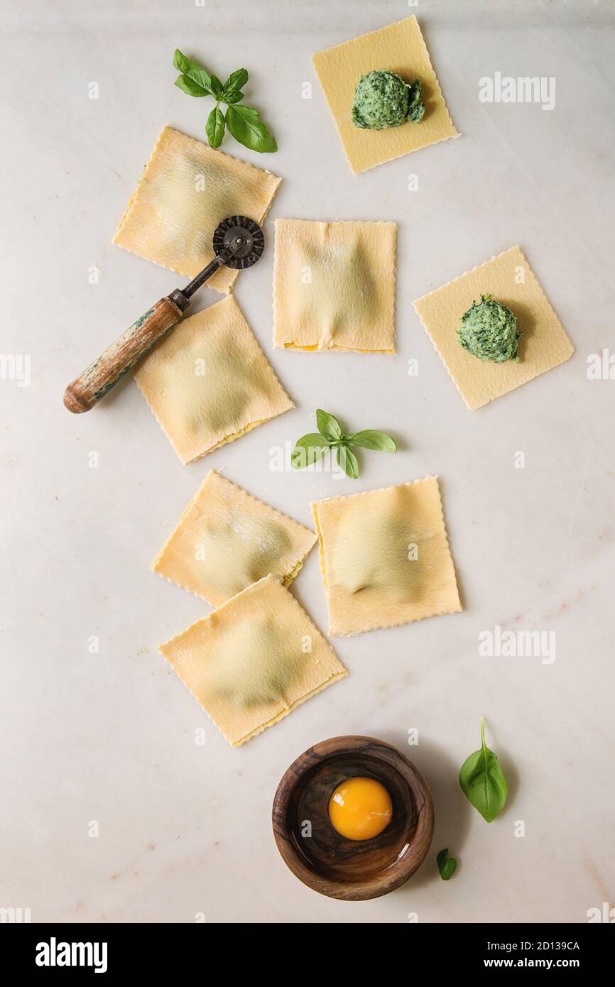 Homemade raw uncooked italian pasta ravioli staffed by spinach ricotta ...