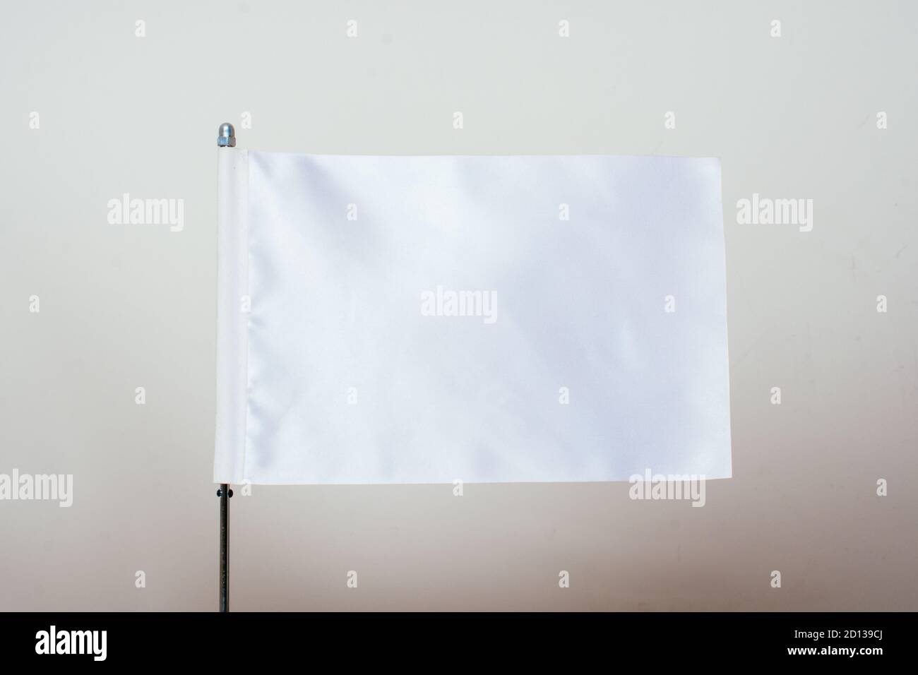 White flag on a white background in the display Stock Photo - Alamy