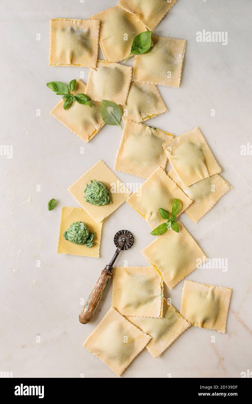 Homemade raw uncooked italian pasta ravioli staffed by spinach ricotta ...
