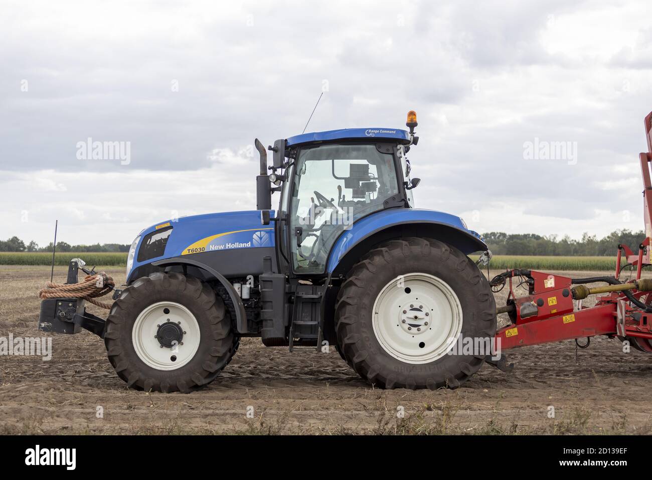 Tractor in farmland field Stock Photo - Alamy