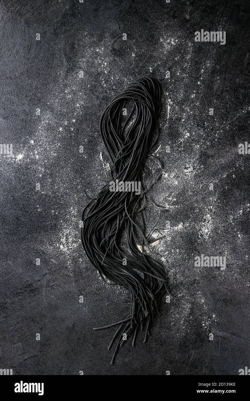 Italian homemade raw uncooked cuttlefish ink black pasta spaghetti with ...