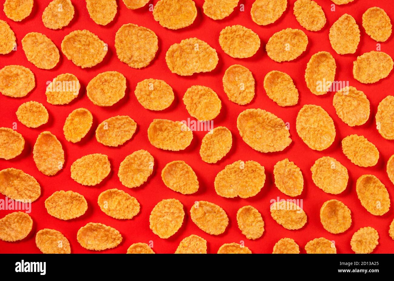 Pattern of corn flakes on red color background, top view Stock Photo ...