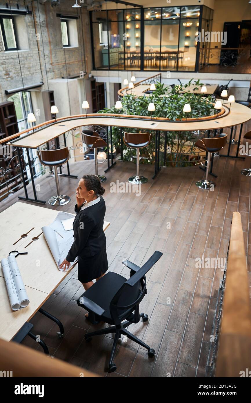 Busy office manager standing at her workplace Stock Photo - Alamy