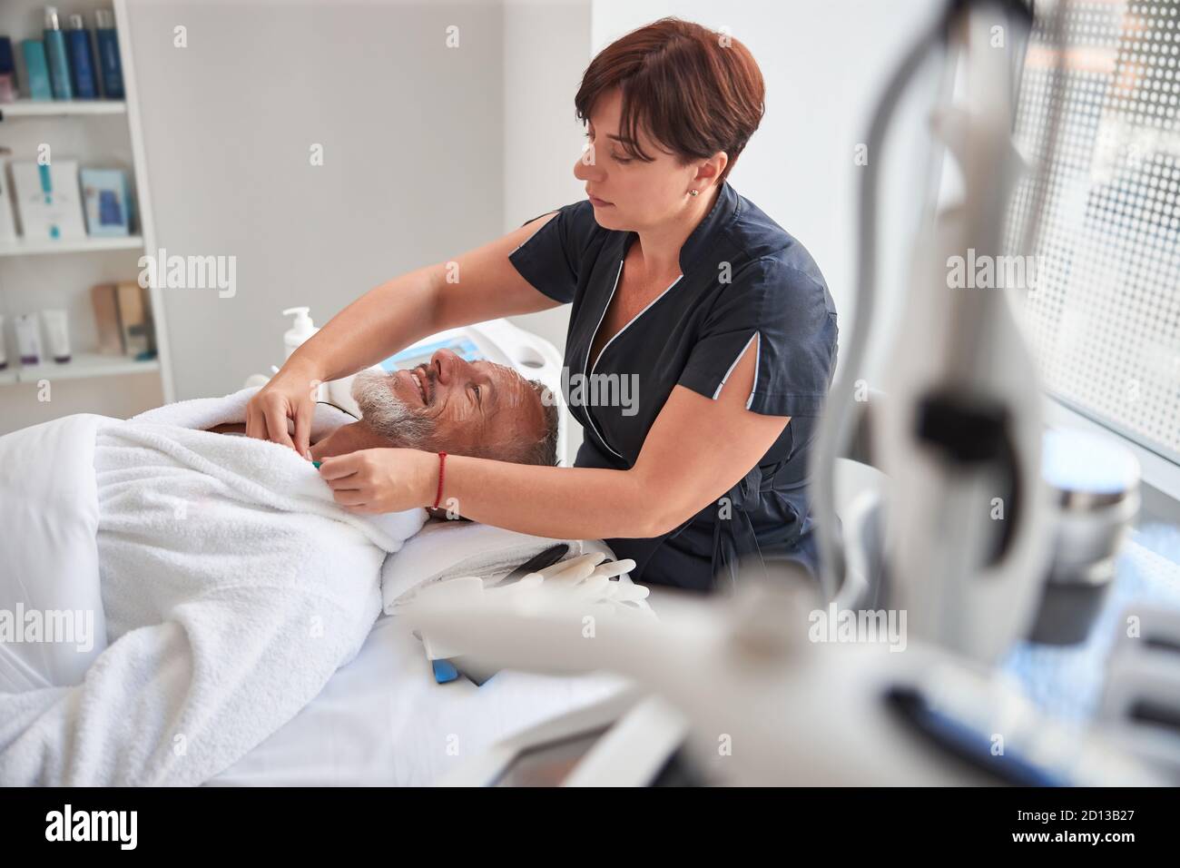 Professional spa therapist preparing man for beauty procedures Stock ...