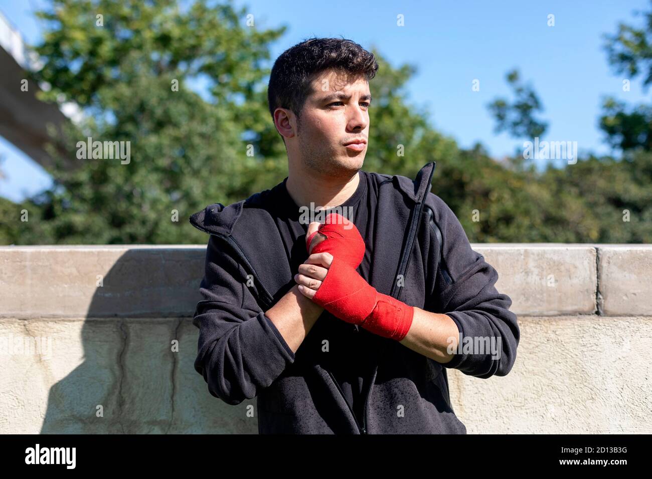 Boxer preparing for training with forearm bandage outdoors Stock Photo ...