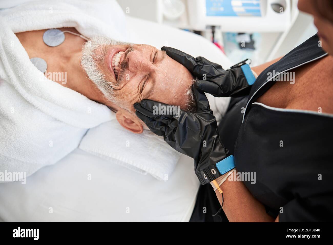 Happy senior citizen receiving facial treatment at spa Stock Photo - Alamy