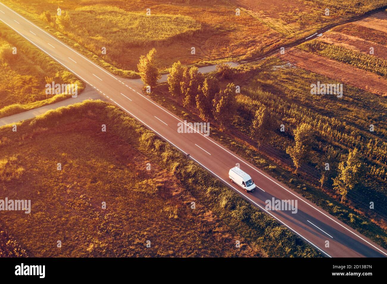 Aerial view of delivery truck minivan on the road in summer sunset ...
