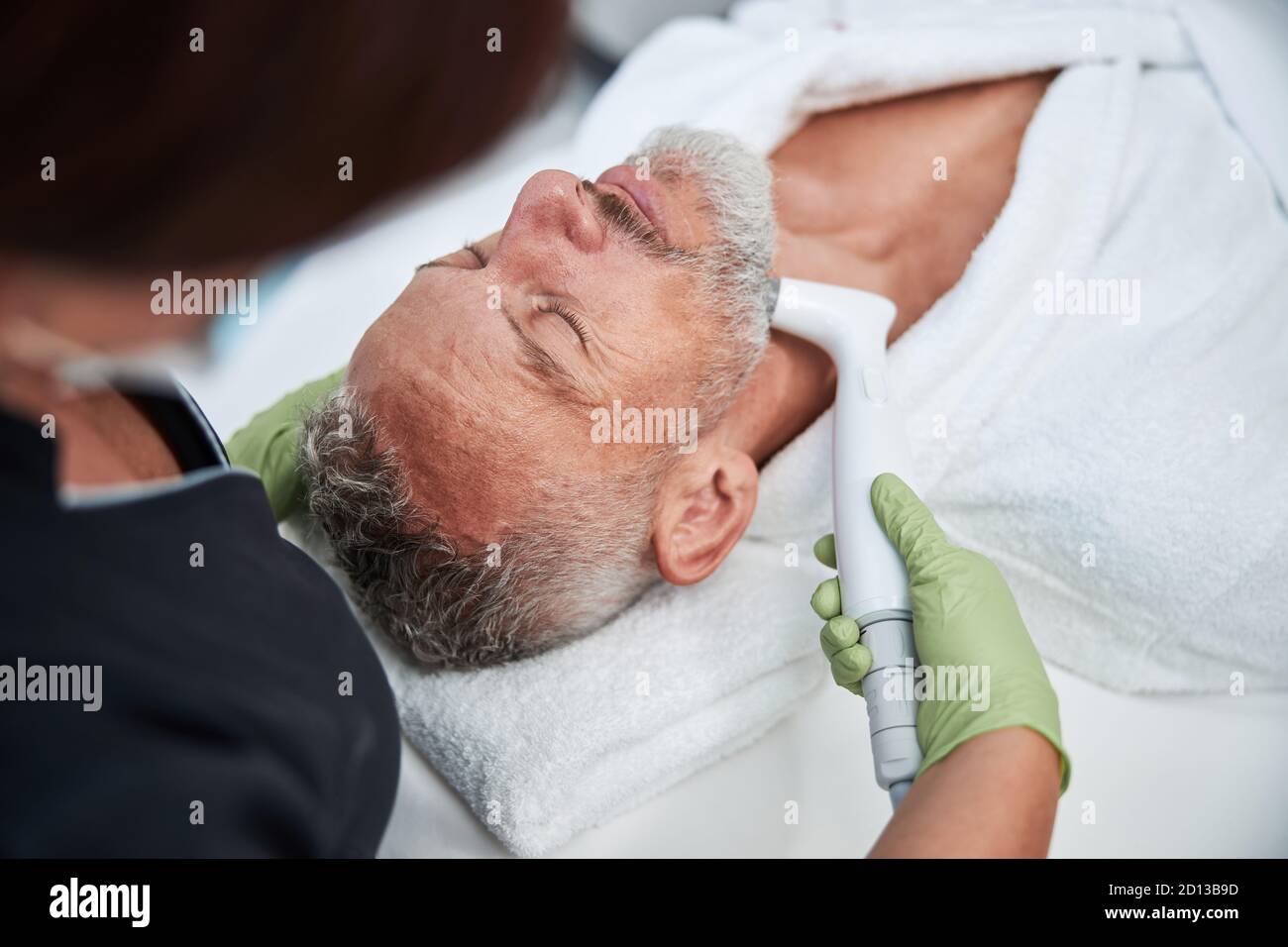 Senior citizen enjoying facial skin treatment at spa Stock Photo - Alamy