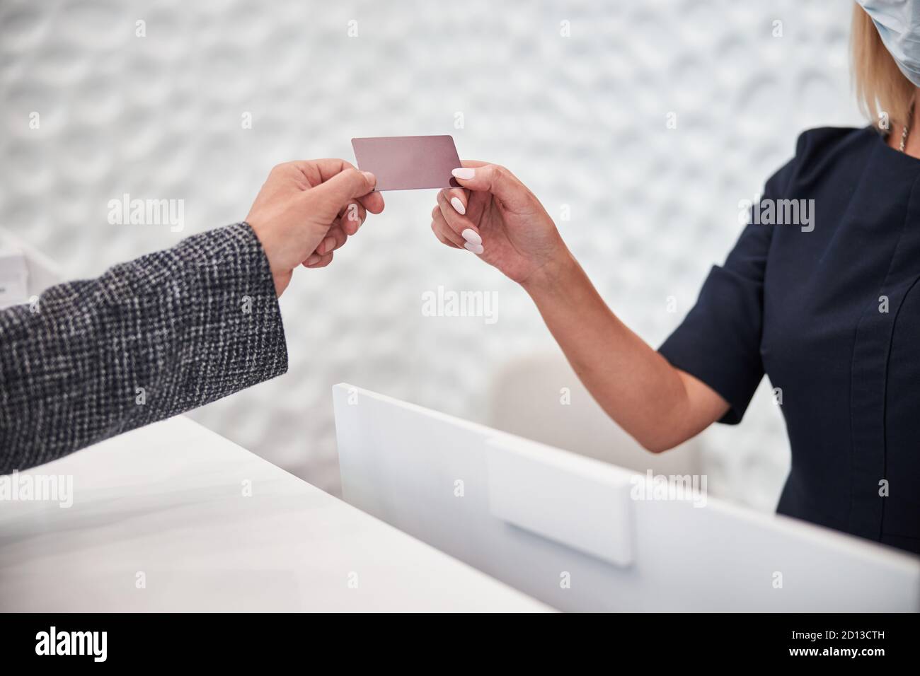 Customer of a shop receiving a plastic discount card Stock Photo - Alamy