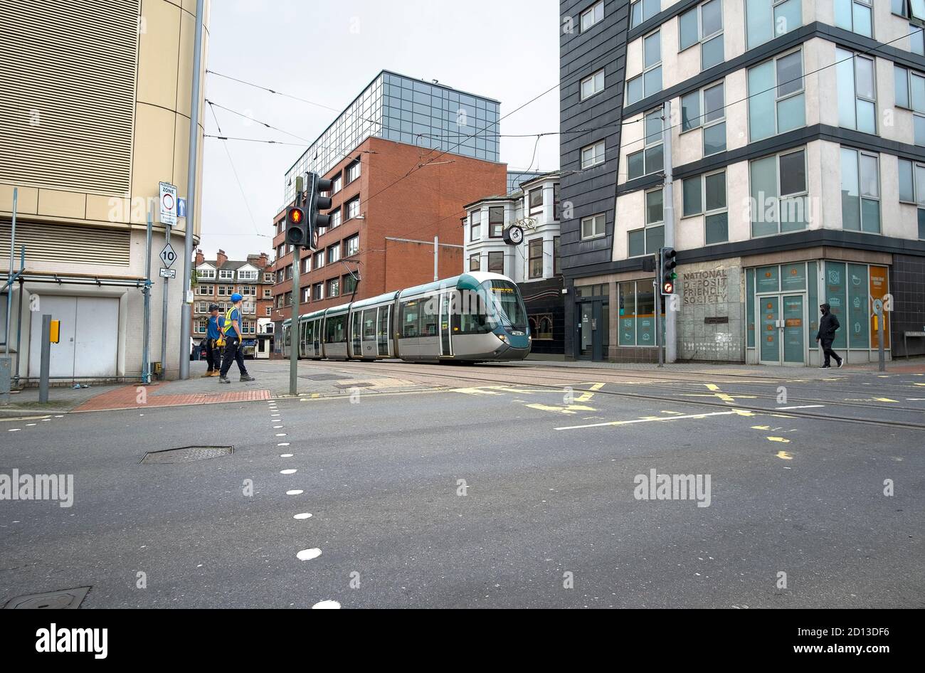 Tram crossing a city road junction Stock Photo - Alamy