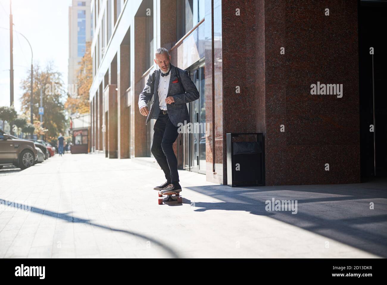 Active elderly gentleman is riding his longboard Stock Photo - Alamy