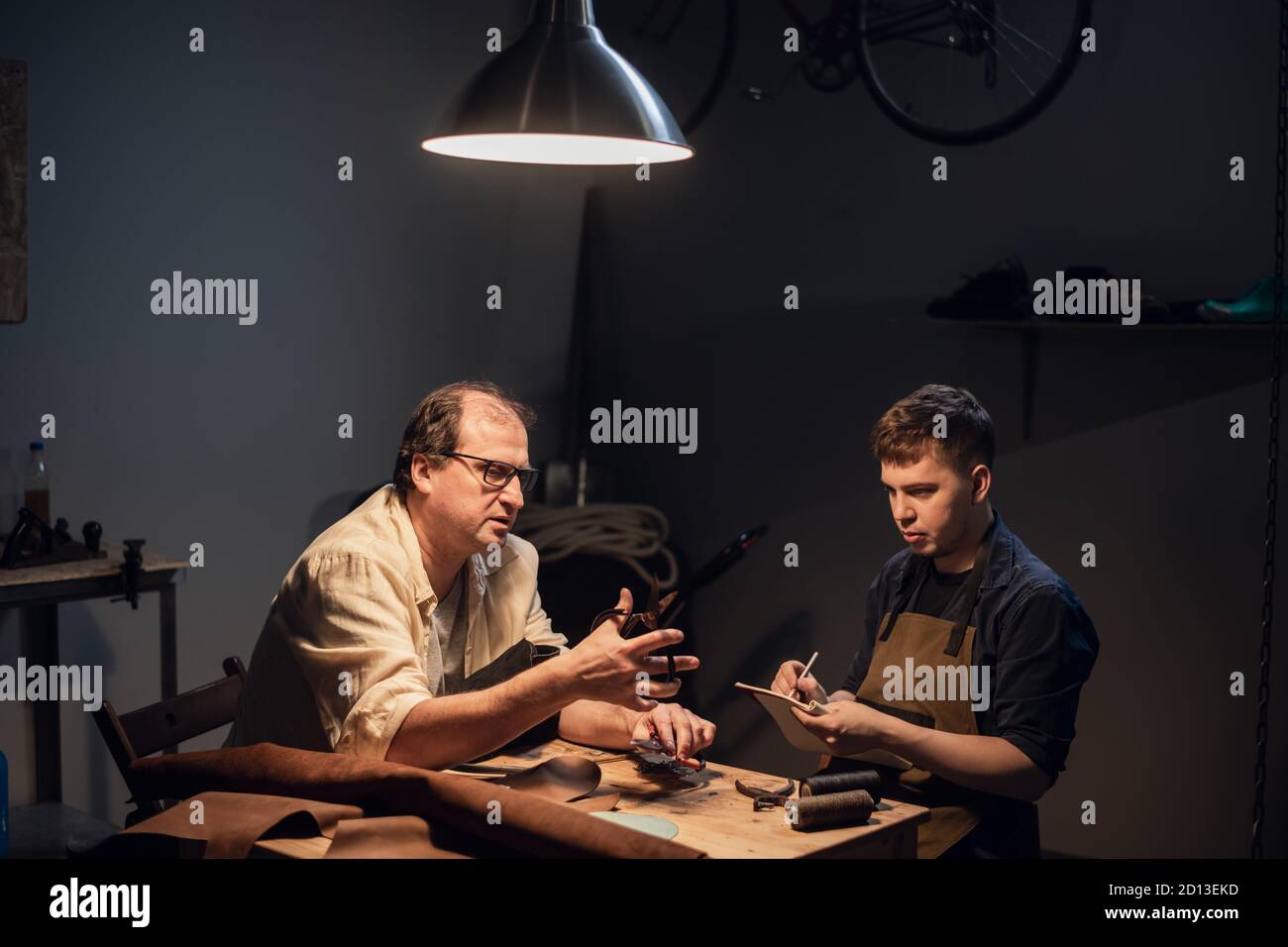 father-shoemaker prepares a successor in the family business of manual ...
