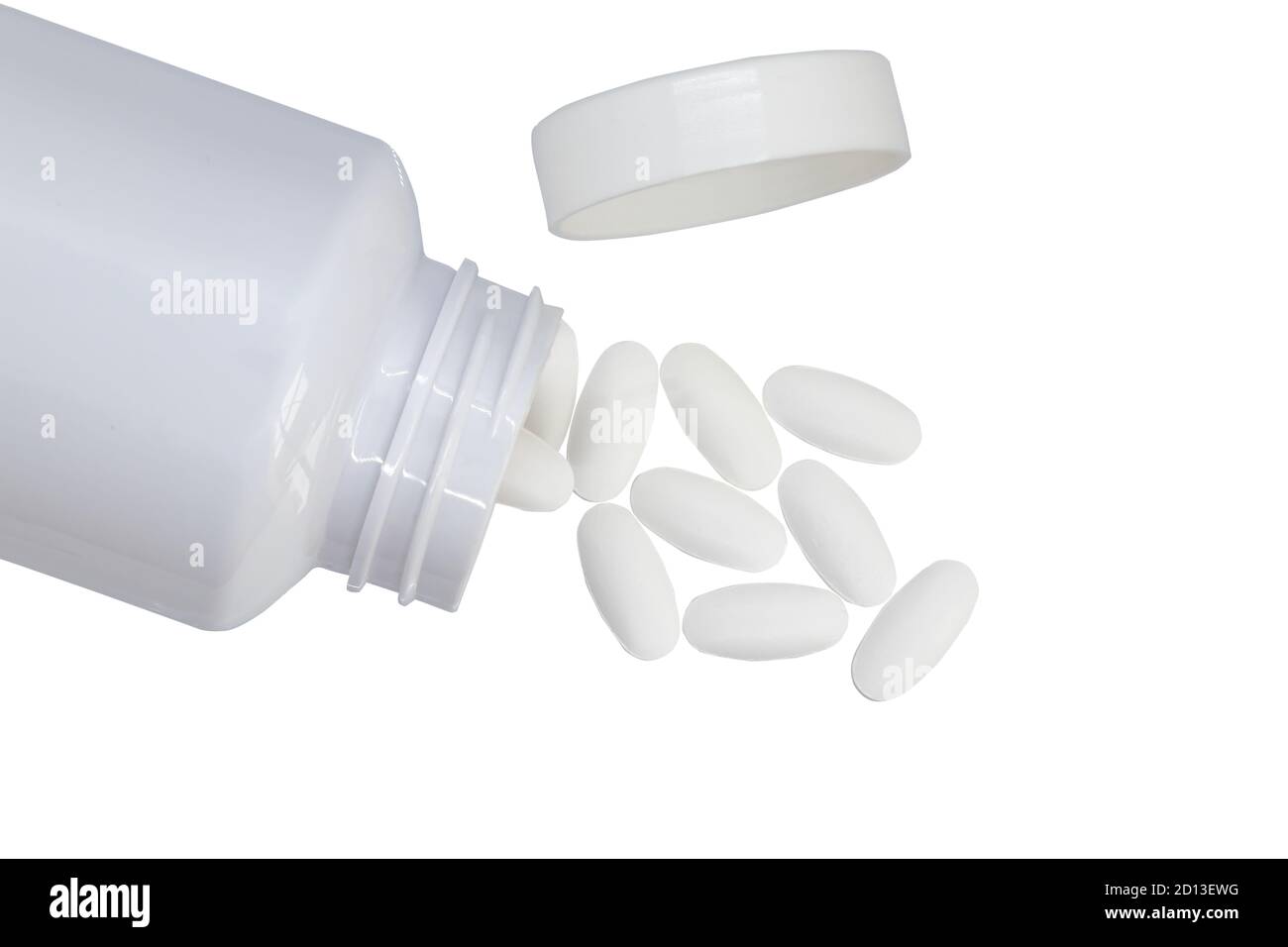 Open bottle of medicine and its lid of pills. Several pills are lying ...