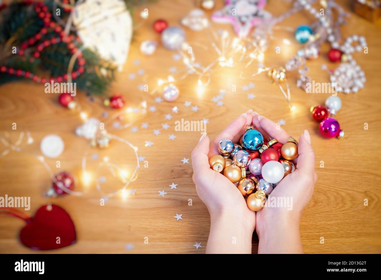 Christmas concept. Human hands hold a glass christmas baubles with ...