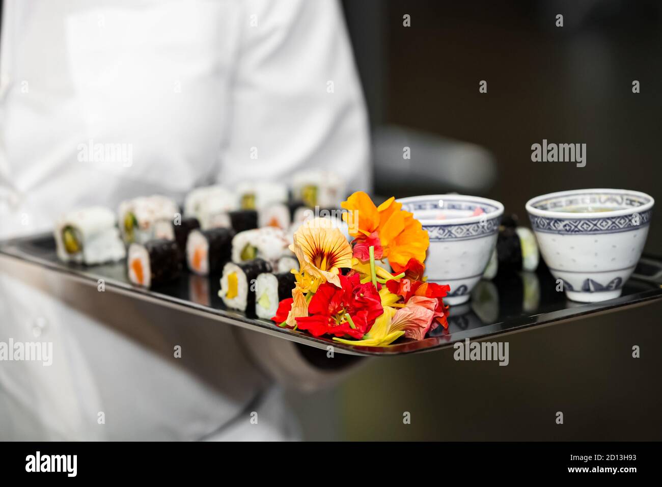 Sushi starters on a tray being held by a waiter Stock Photo - Alamy