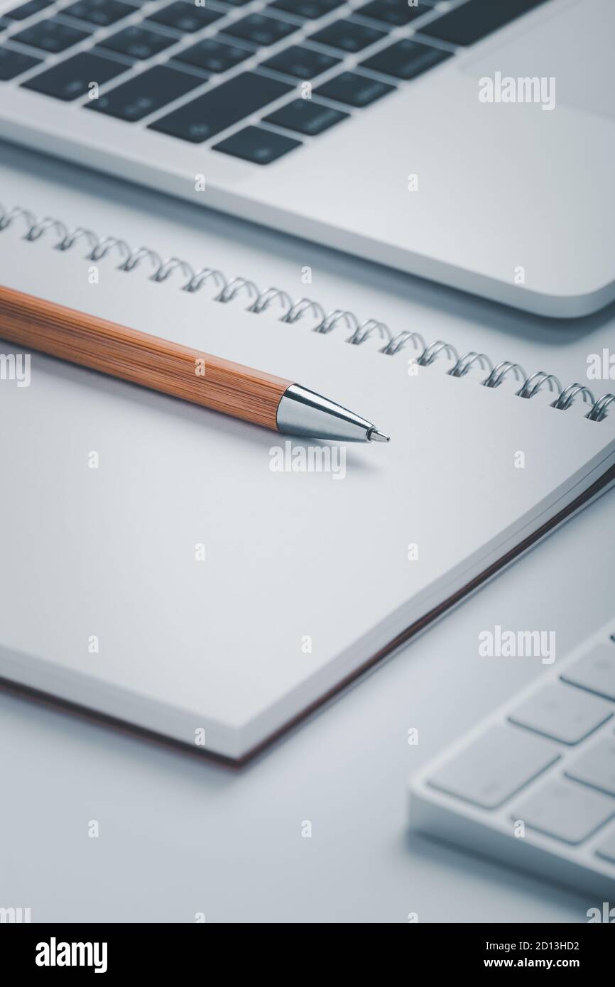 Closeup shot of brown pen with notebook and laptop on workspace Stock ...