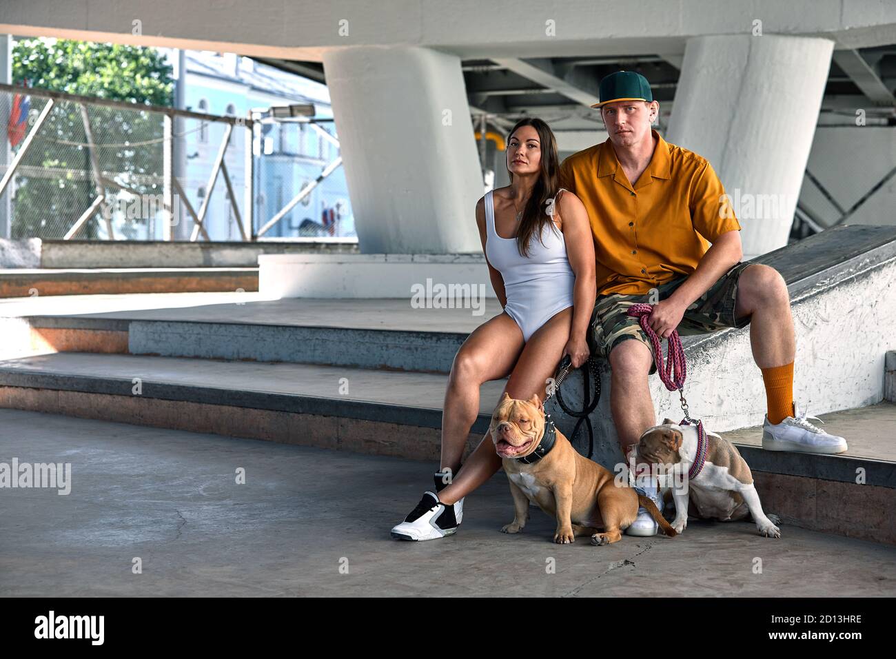 young stylishly dressed man and woman with an athletic figure with two ...