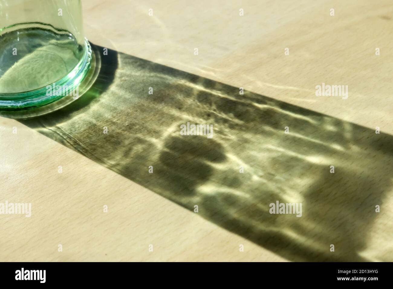 Sunlight shining through a drinking glas showing caustic light effects ...