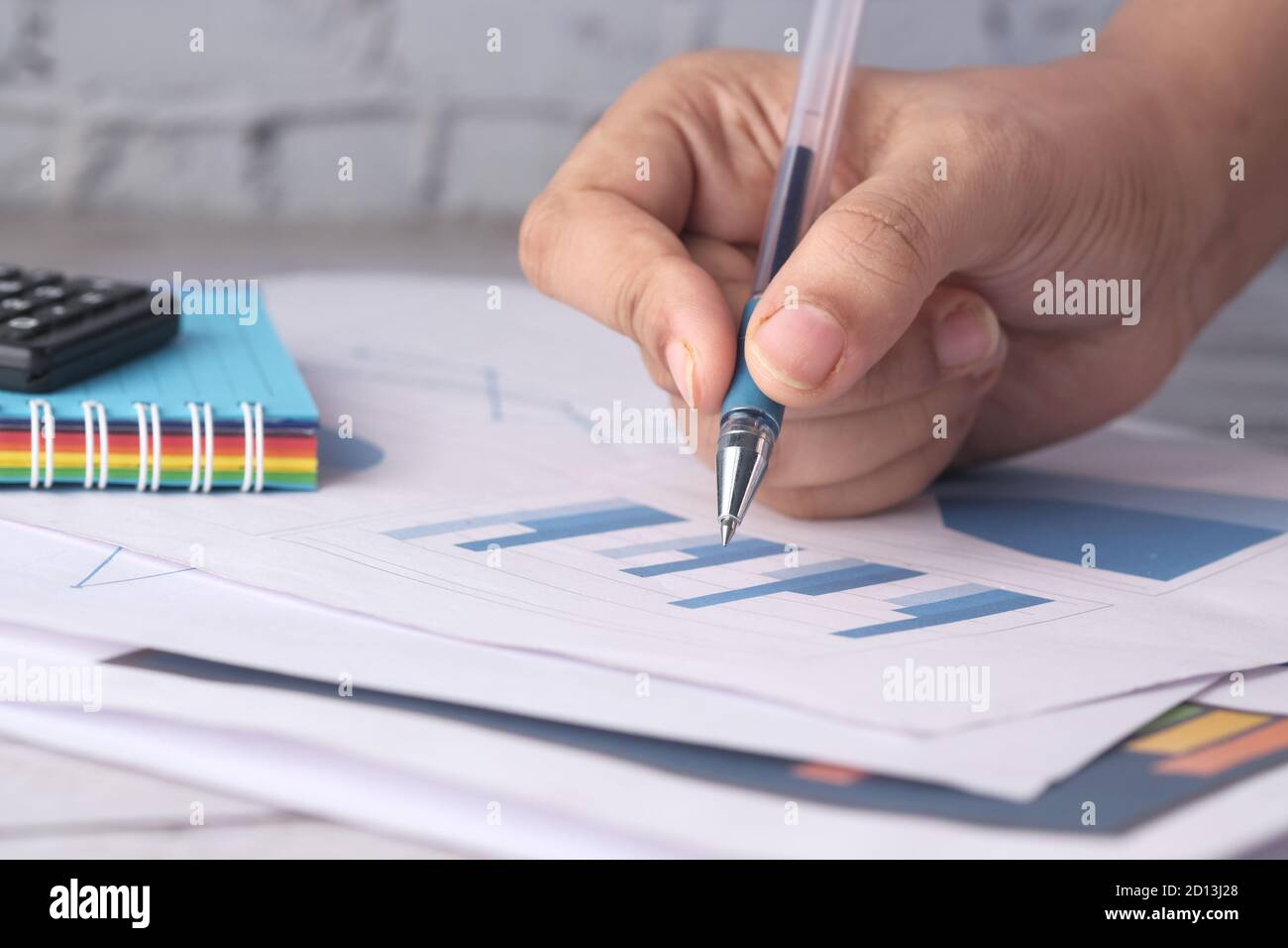 women hand with pen analyzing bar chart on paper Stock Photo - Alamy