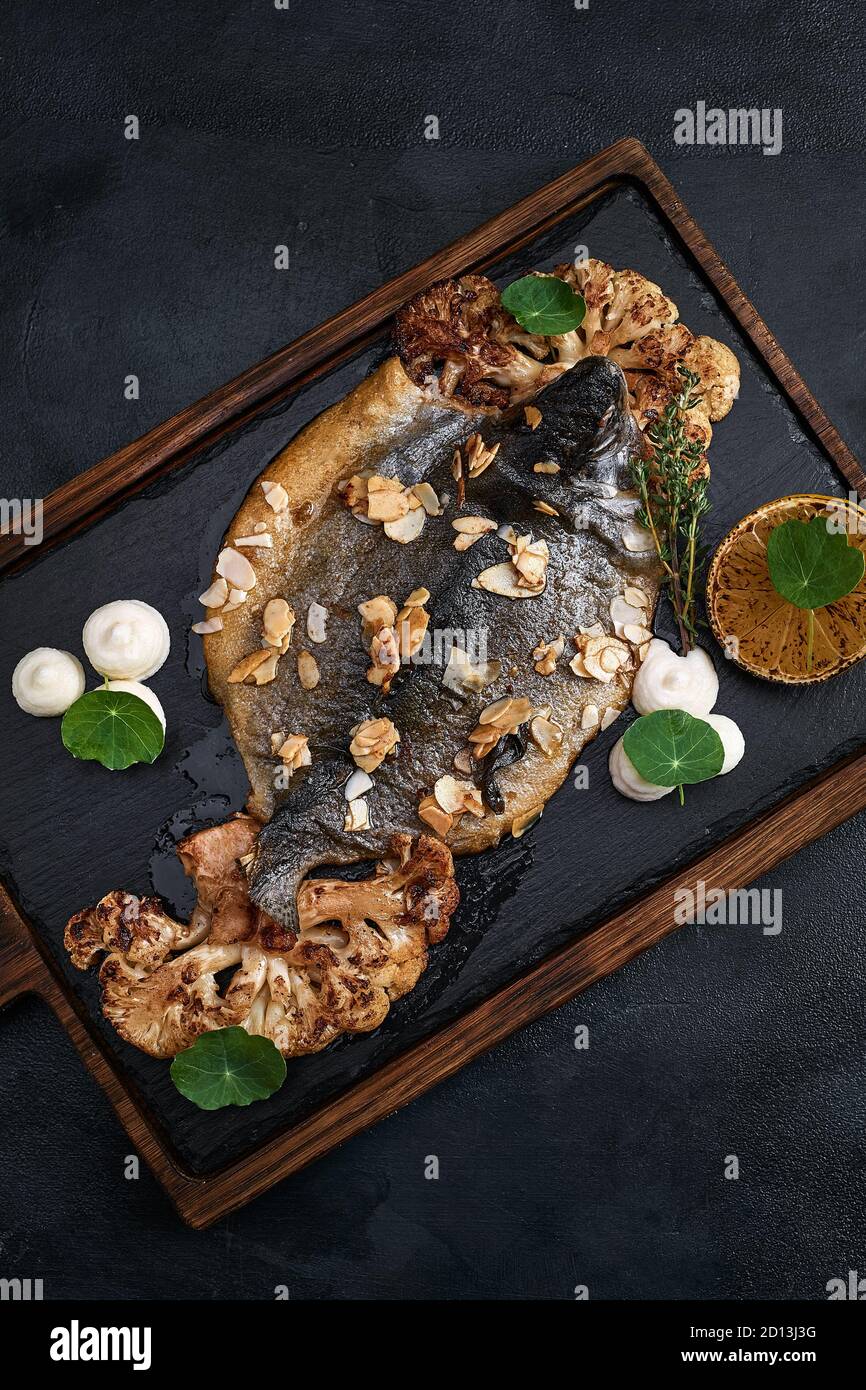 Fish dishes cooking preparation with dorado in backing form in shape of ...