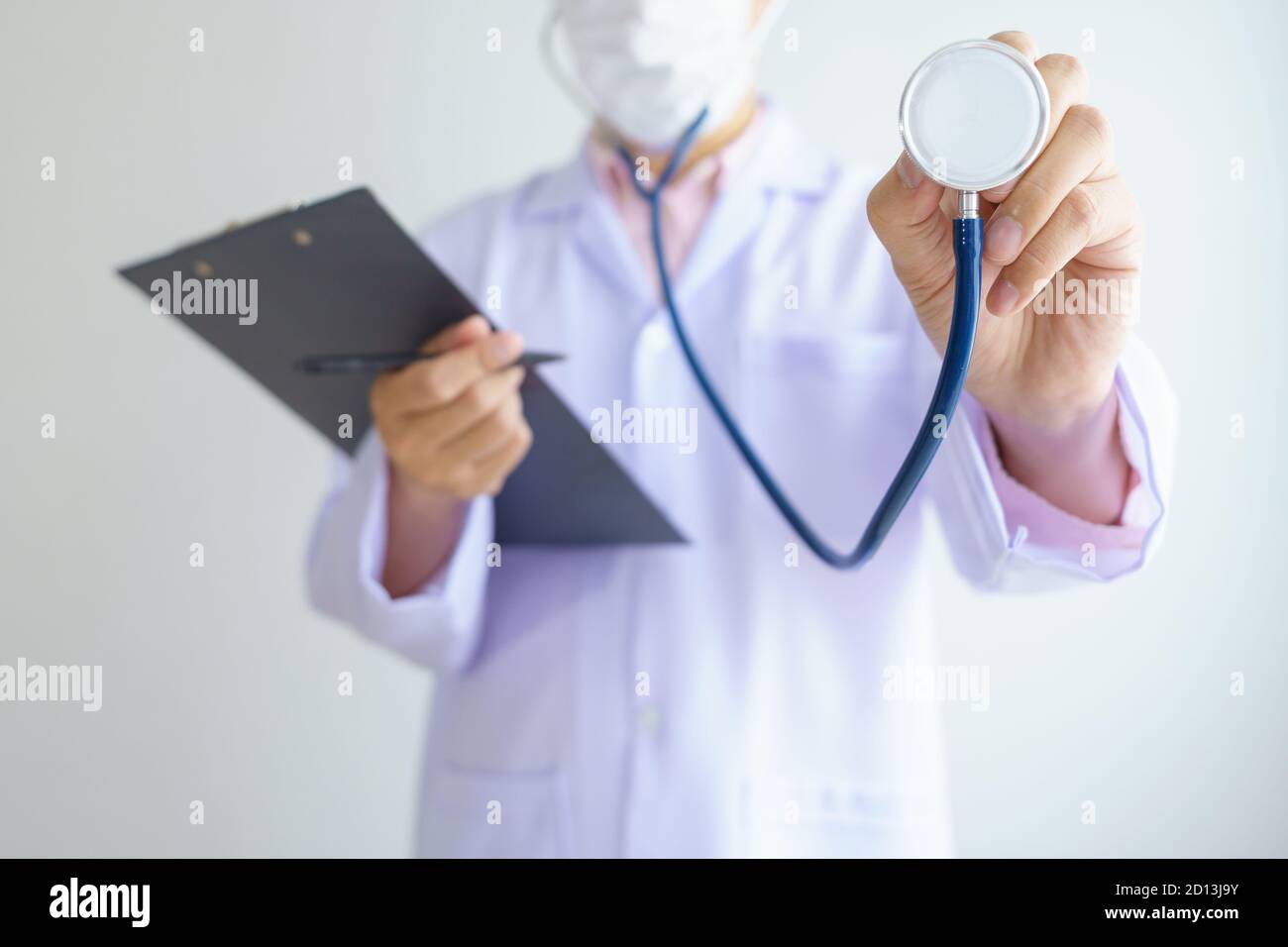 Male asian doctor working in the office hospital wearing face mask ...