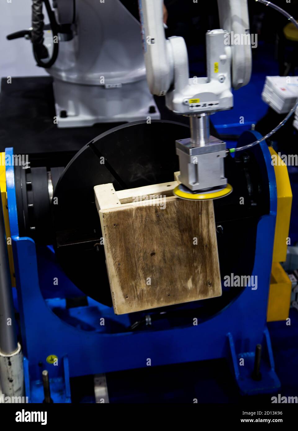 Automated robotic arm polishing wooden chair. Hi-technology industrial ...