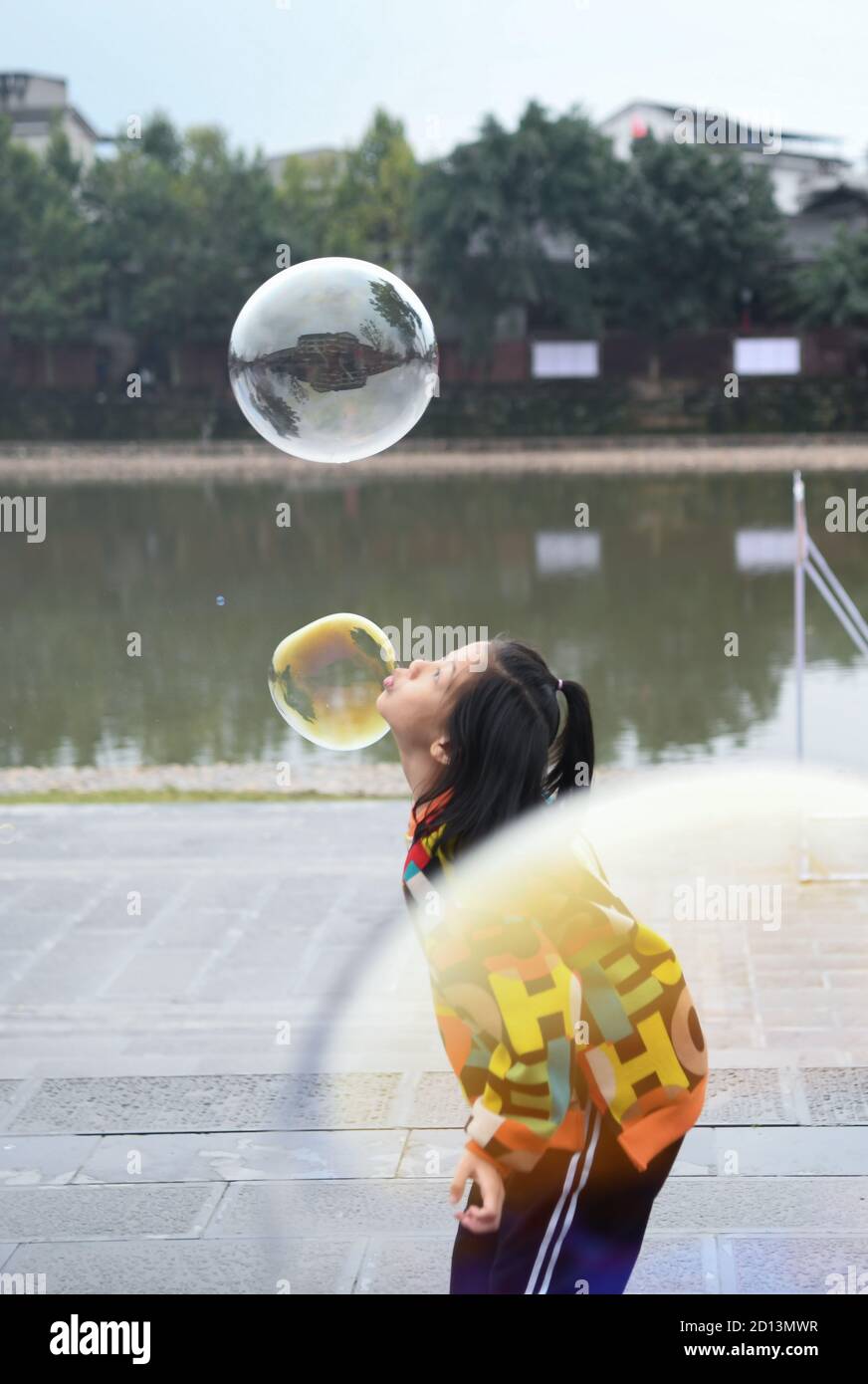 Leshan. 5th Oct, 2020. A girl plays at a town in Shizhong District of ...