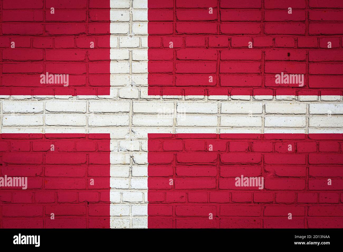 National flag of Denmark depicting in paint colors on an old brick wall ...