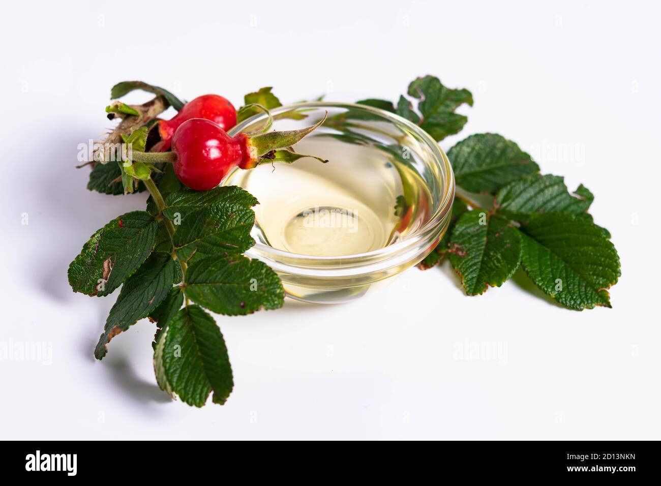 isolate, oil and rose hips on a white background Stock Photo - Alamy