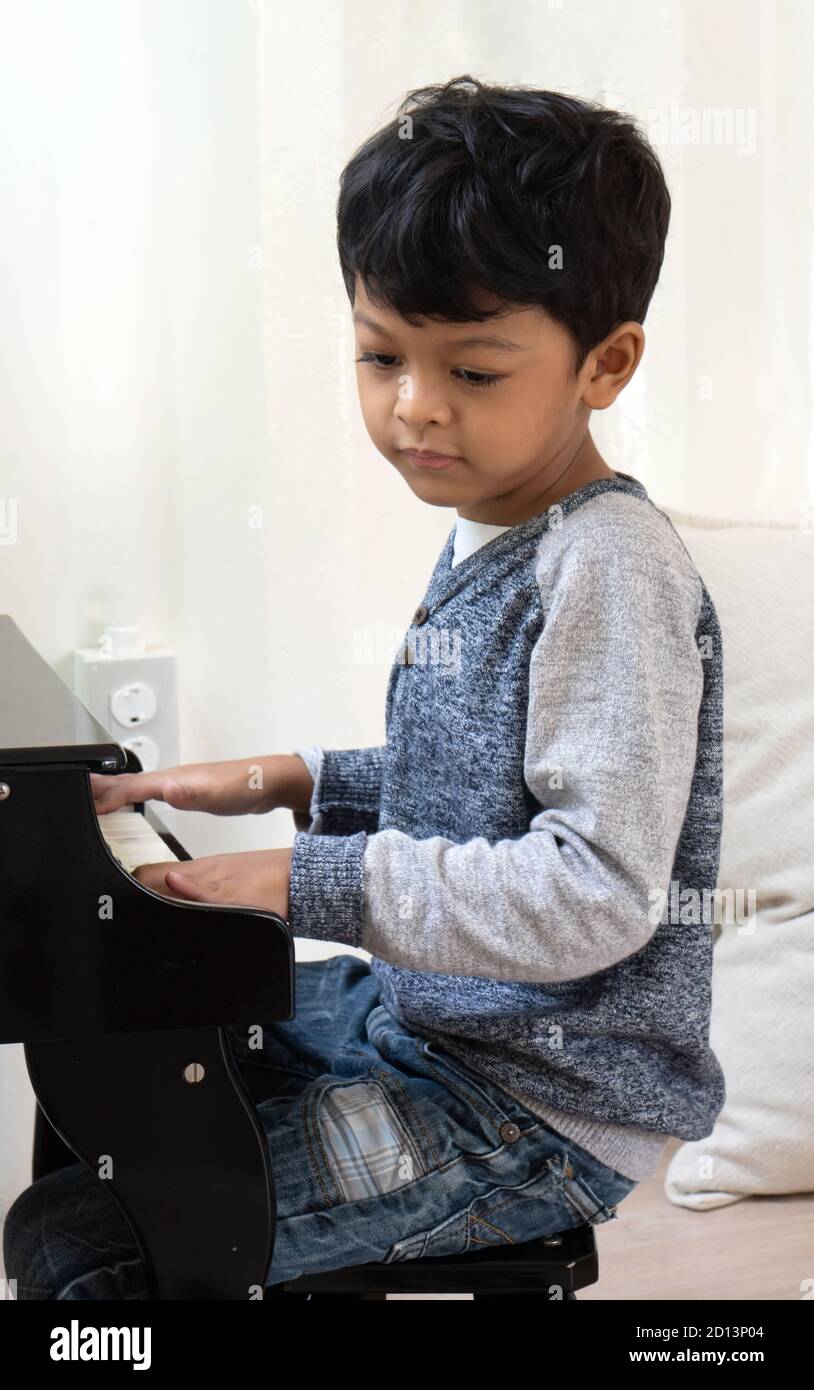 Boy practicing piano at home hi-res stock photography and images - Alamy